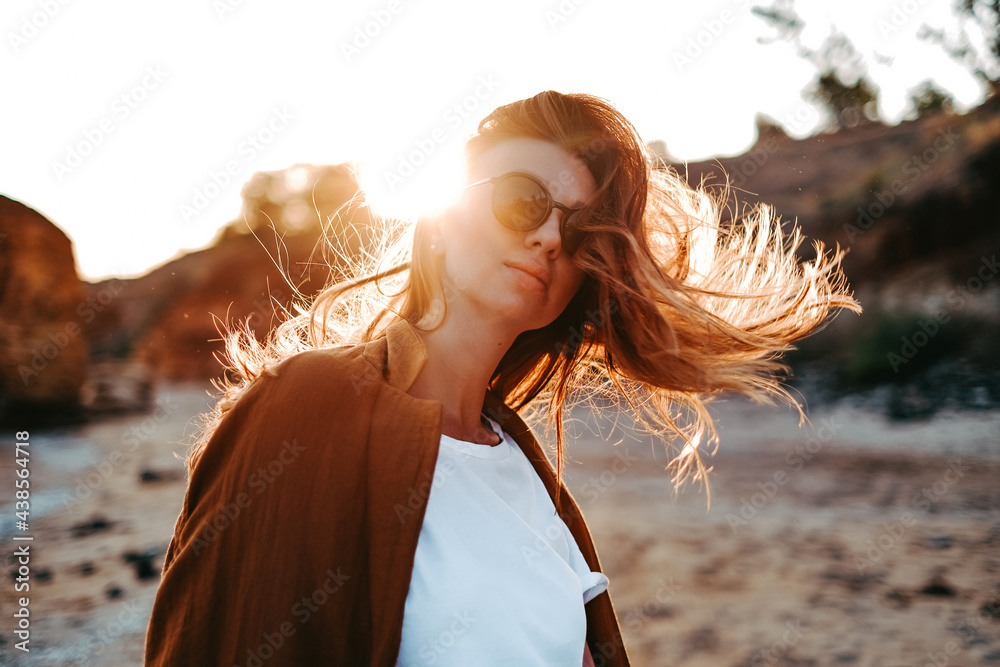 portrait of a beautiful girl at sunset. the wind develops hair harmony ...