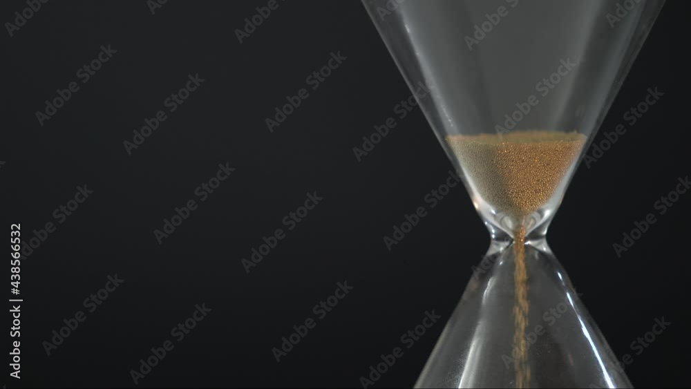 Hourglass. Sands move through hour glass. Close up. Pass of time and ...