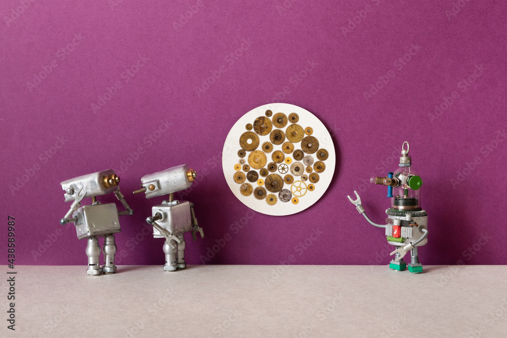 A robot museum guide leads a tour for two young robots, who are looking ...