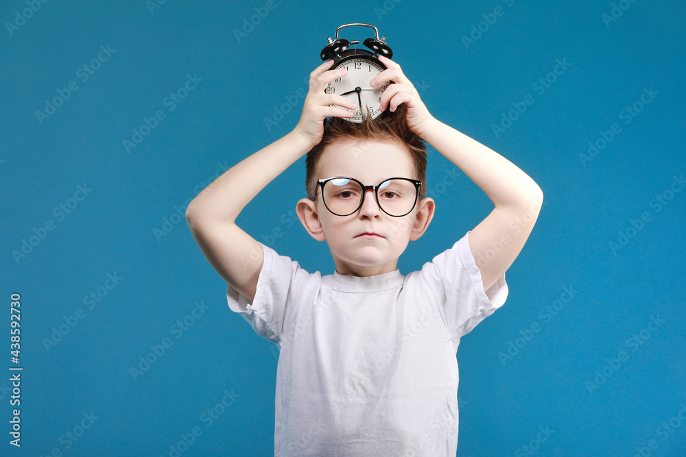 Time management. Morning. little boy with alarm clock. Happy childhood ...