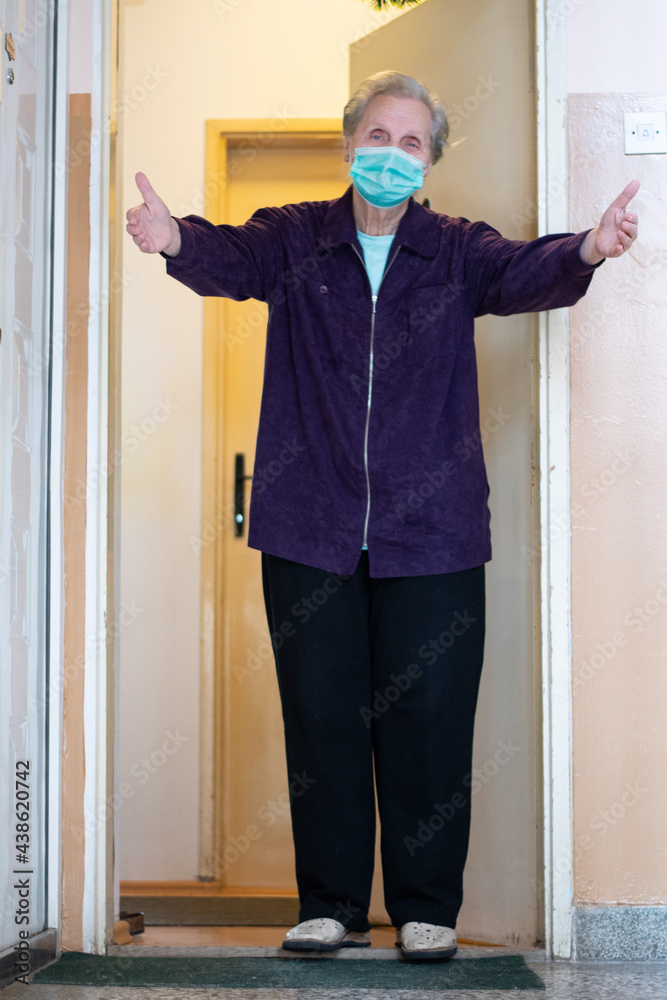 Hug me Photo of grandma spread open arms wear mask in a purple shirt in ...