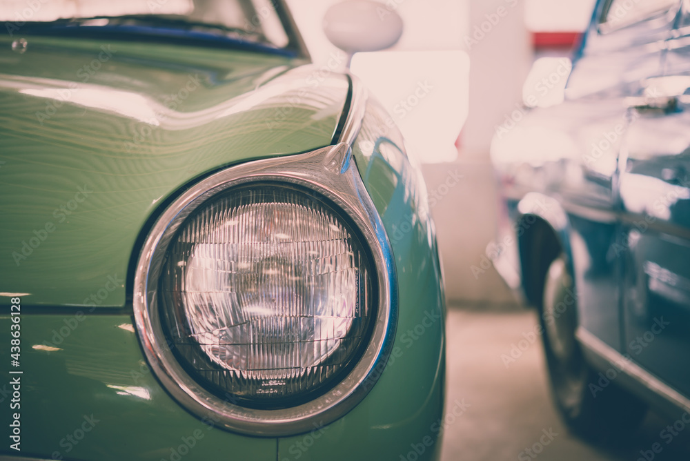 Close up round headlights of green vintage classic car. Transportation ...