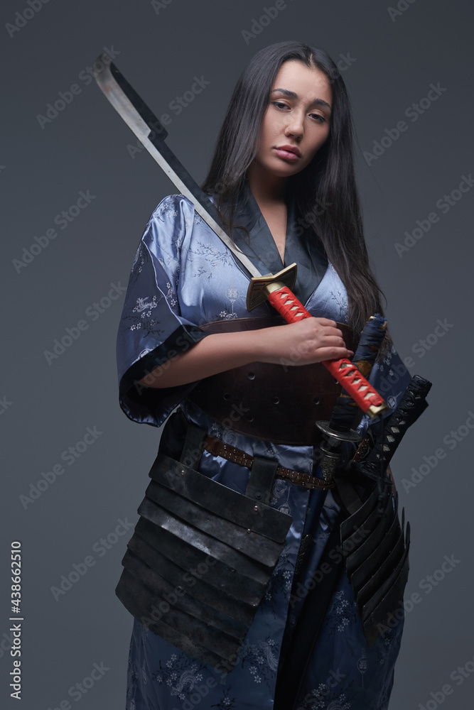 Female samurai holding katana on her shoulder Stock Photo | Adobe Stock