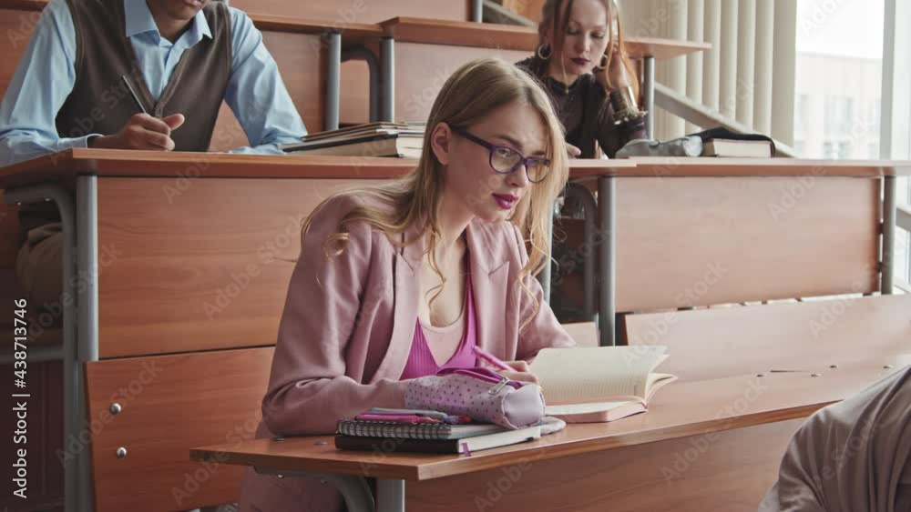 Medium slowmo of beautiful young female student wearing glamour pink ...