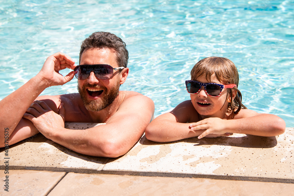 Father and son in pool. Pool party. Child with dad playing in swimming ...