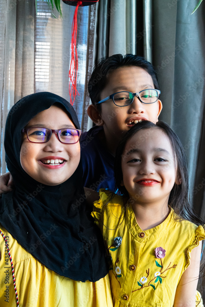 Older sister with siblings. Asian Muslim kids. Happy children during ...