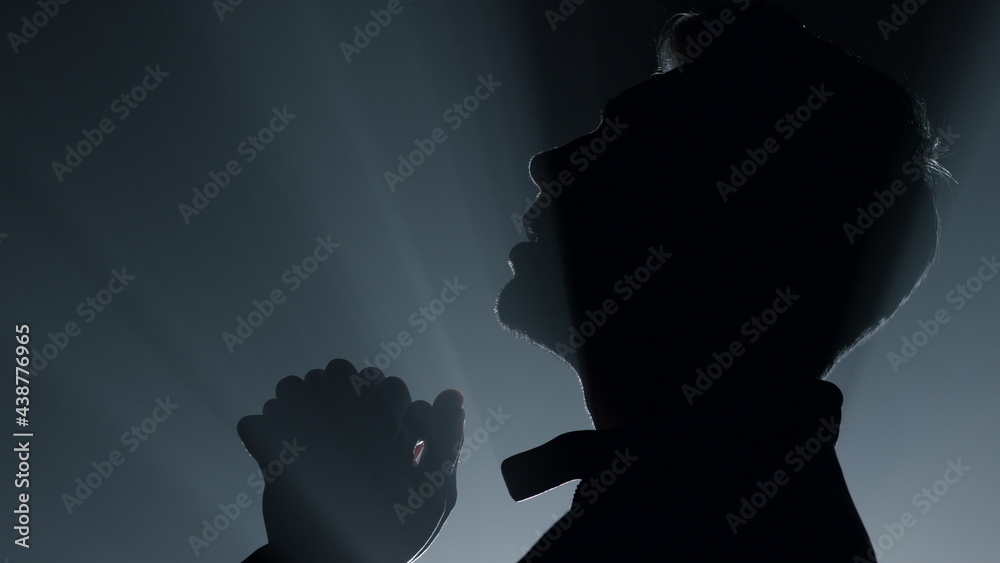 Silhouette religious man asking god blessing. Male person praying in ...