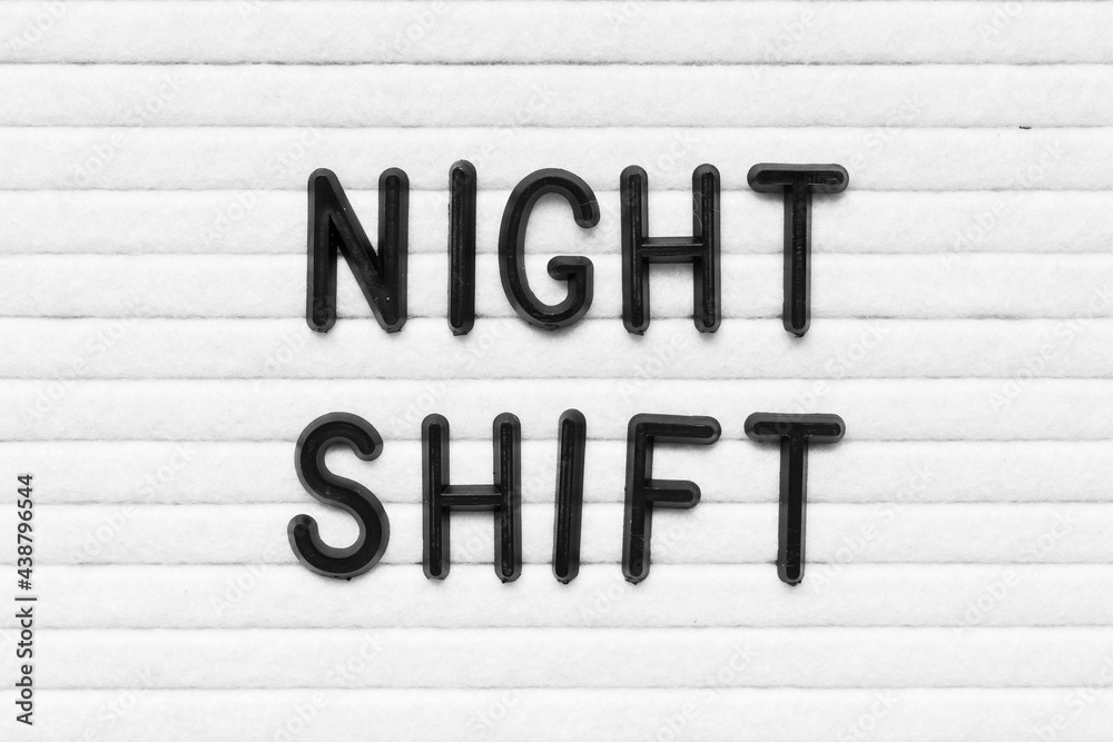Black alphabet letter in word night shift on white felt board ...