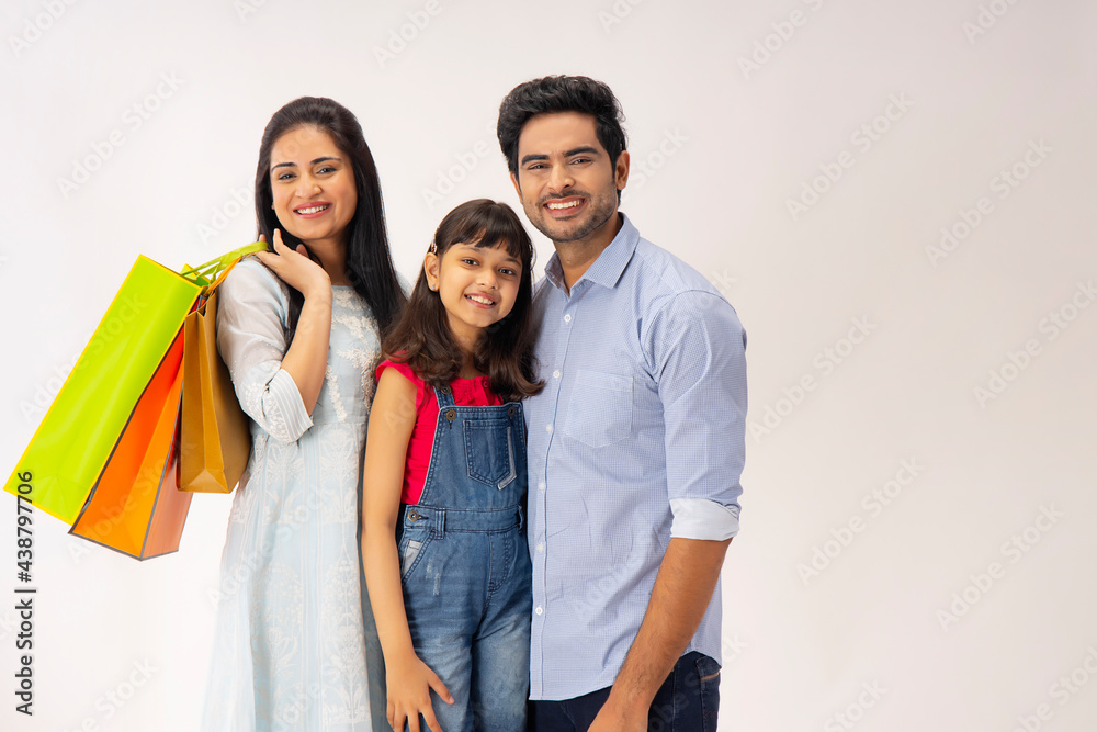A HAPPY FAMILY POSING IN FRONT OF CAMERA AFTER SHOPPING Stock Photo ...