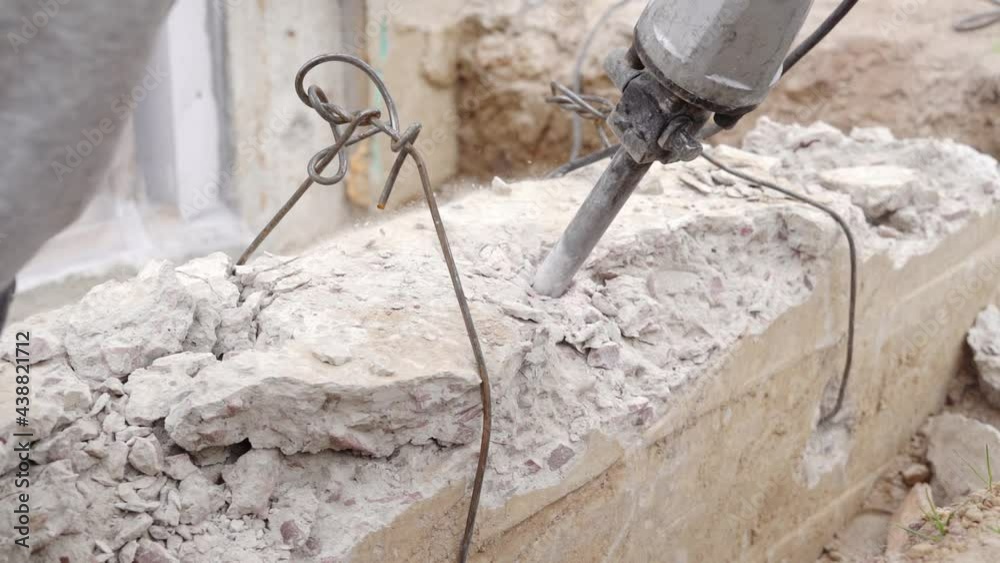 Punching solid concrete with a special jackhammer close-up, in slow ...