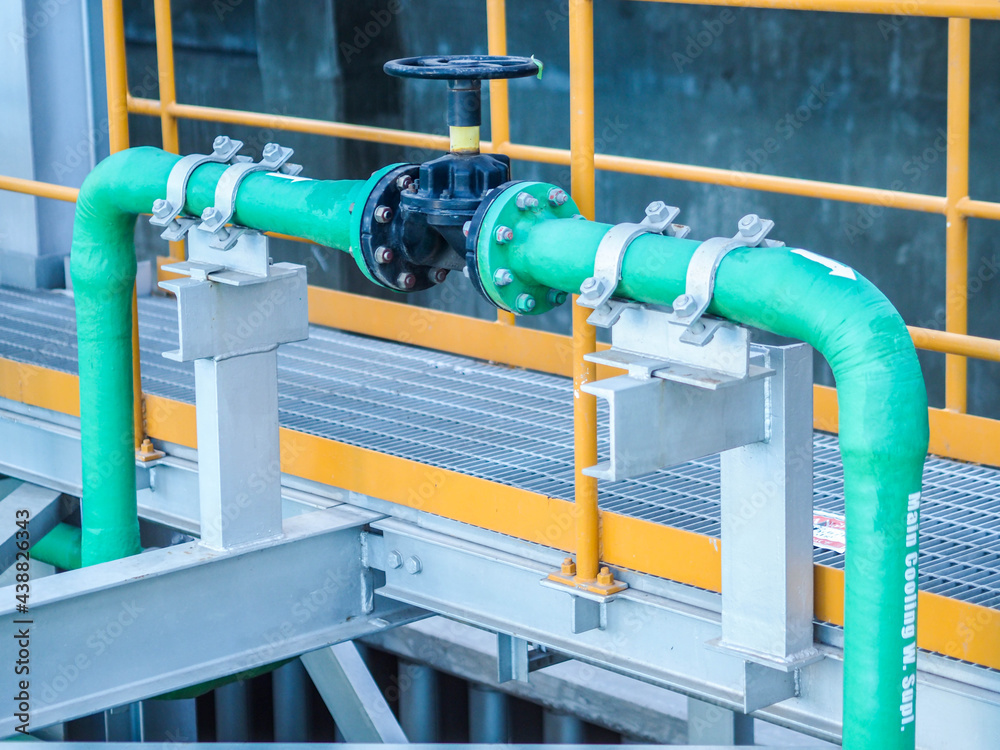 Manual valve and green pipe of cooling water in power plant. Stock ...