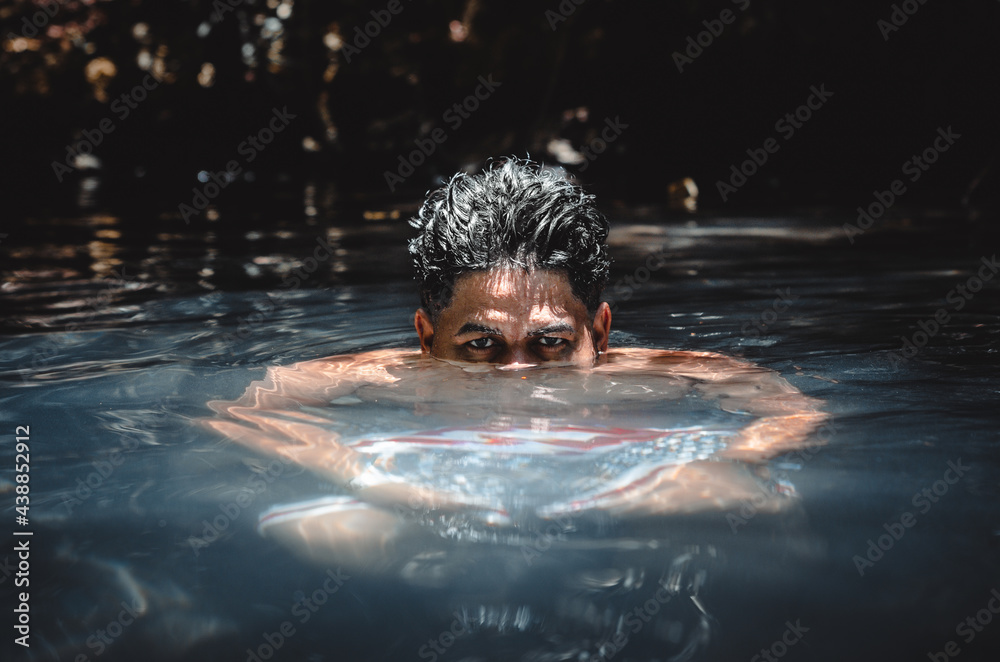 man coming out of the water in the lake as if to give a scare, half of ...