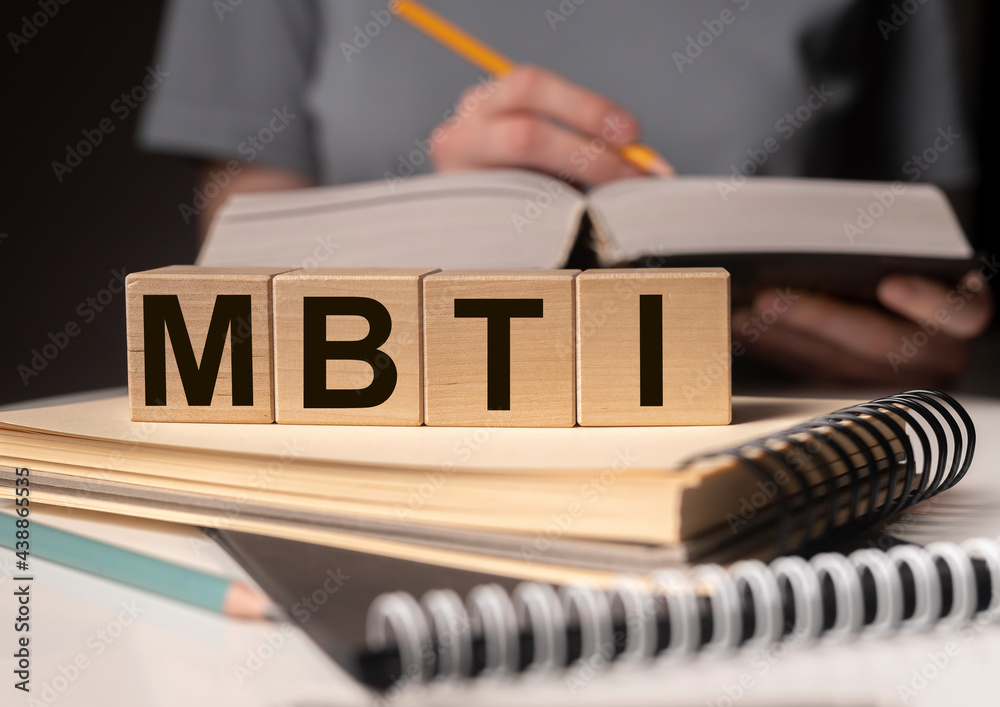 MBTI acronym, word on wood blocks on desk with books. Psychological ...