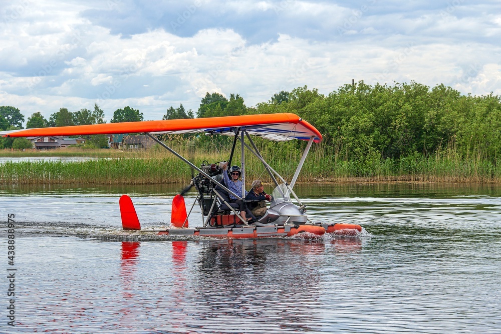 girl flies and floats on a hydro-hang glider. Lake Seliger Lake ...