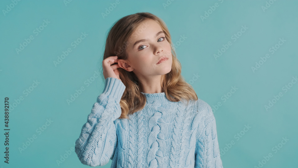 Beautiful serious teenage girl putting her hair behind ear looki Stock ...