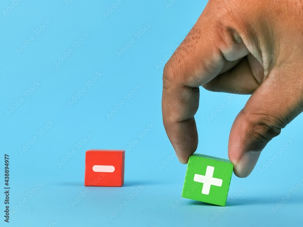 Positive and negative part concept. Hand pick and choose plus symbol on ...