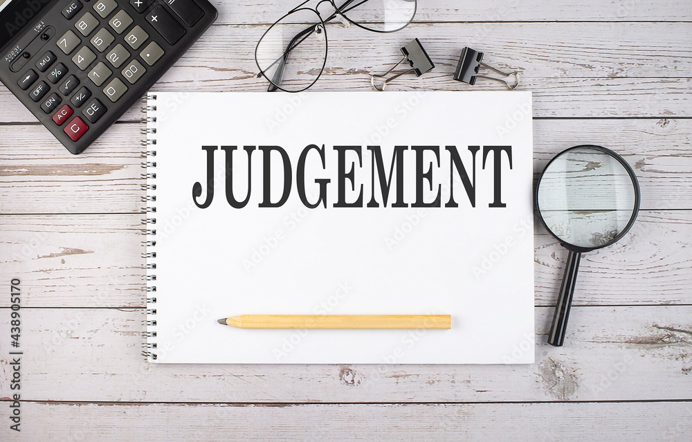 Blank notebook with text JUDGEMENT on white background with calculator ...