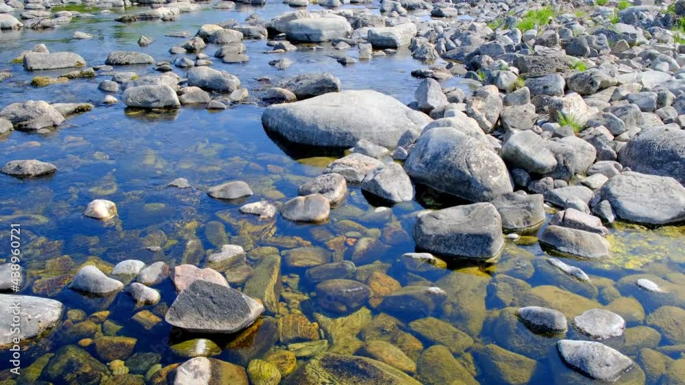 The bed of a dry mountain river in which there is almost no water left ...