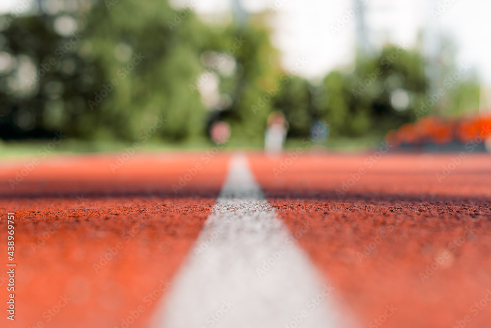 Outdoor stadium jogging track. Texture of red rubberized surface with a ...