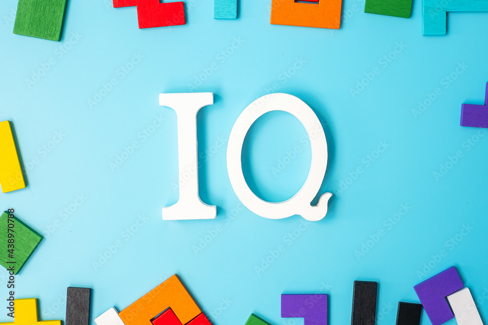 IQ text with colorful wood puzzle pieces, geometric shape block on blue ...
