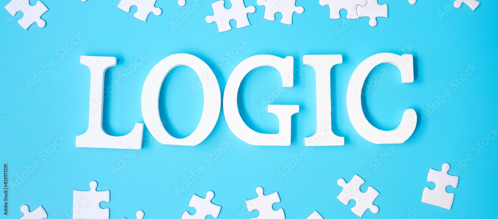 LOGIC text with white puzzle jigsaw pieces on blue background. Concepts ...
