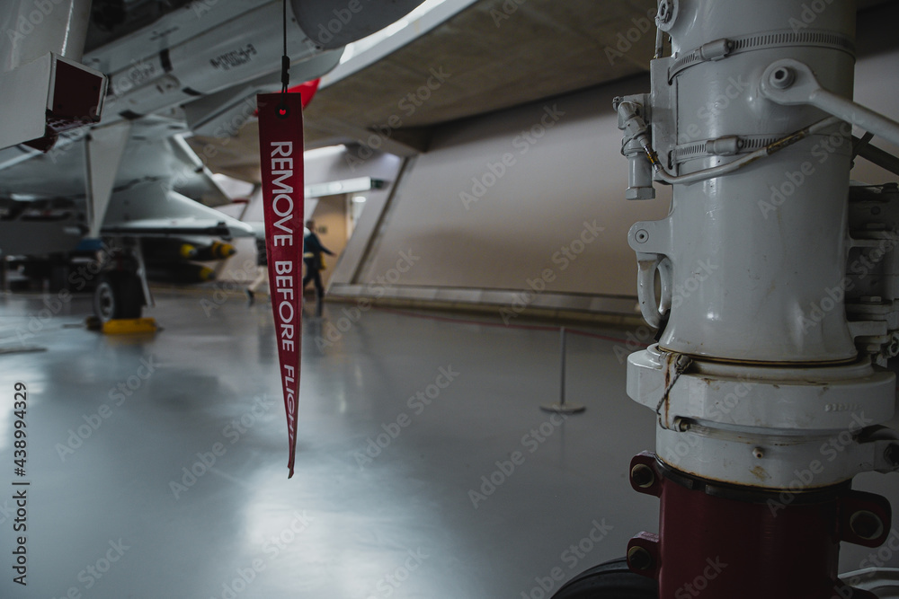 Red ribbon stating Remove Before Flight, attached to a fighter jet as a ...