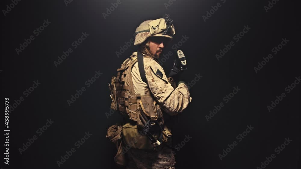 Military man marine Soldier turns to look at viewer then aims rifle ...