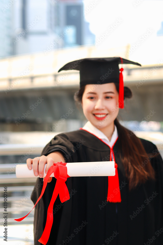 Foto de Happy smiling graduated student, young beautiful Asian woman ...