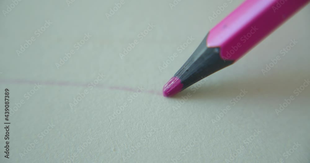 Purple graphite pencil color draws a straight line on a white ...