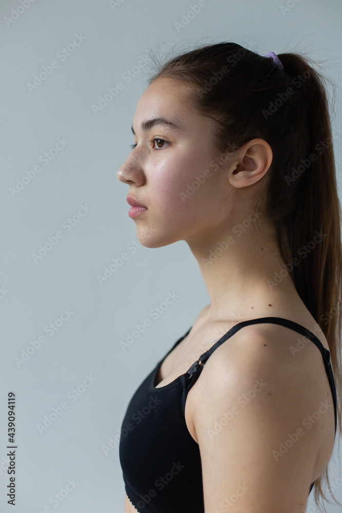 Natural beauty brunette model no make up in swimsuit posing in studio ...