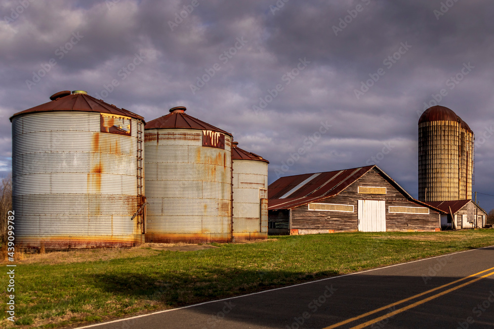 Vintage abandoned farm with barn and six silos Stock Photo | Adobe Stock