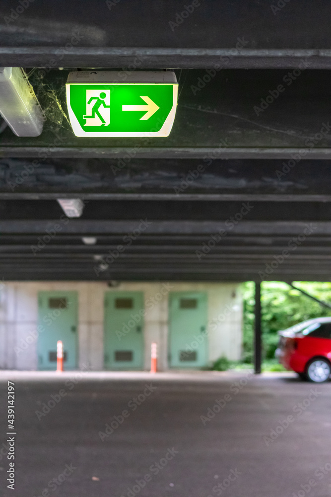Green exit sign with running person and green arrow shows guidance ...