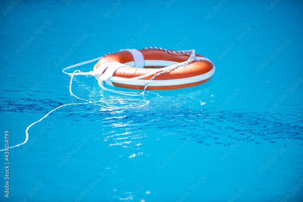 Life buoy for safety at pool in water. Safety equipment, rescue buoy ...