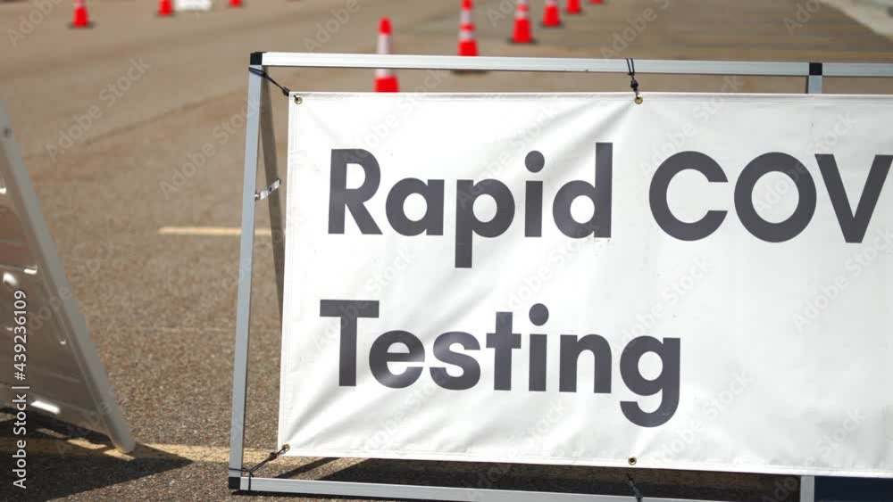 Rapid Covid-19 Testing site sign posted outside on sunny and hot summer ...