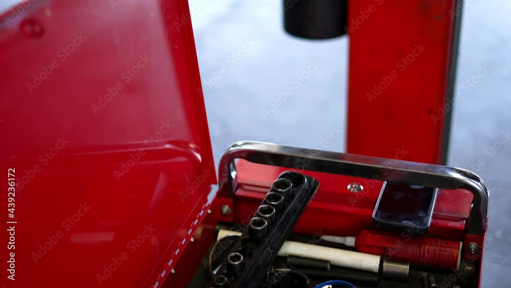 Vidéo Stock Mechanics bright red toolbox full of tools, with cell phone ...