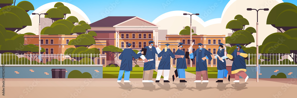 graduated students standing near university building graduates ...