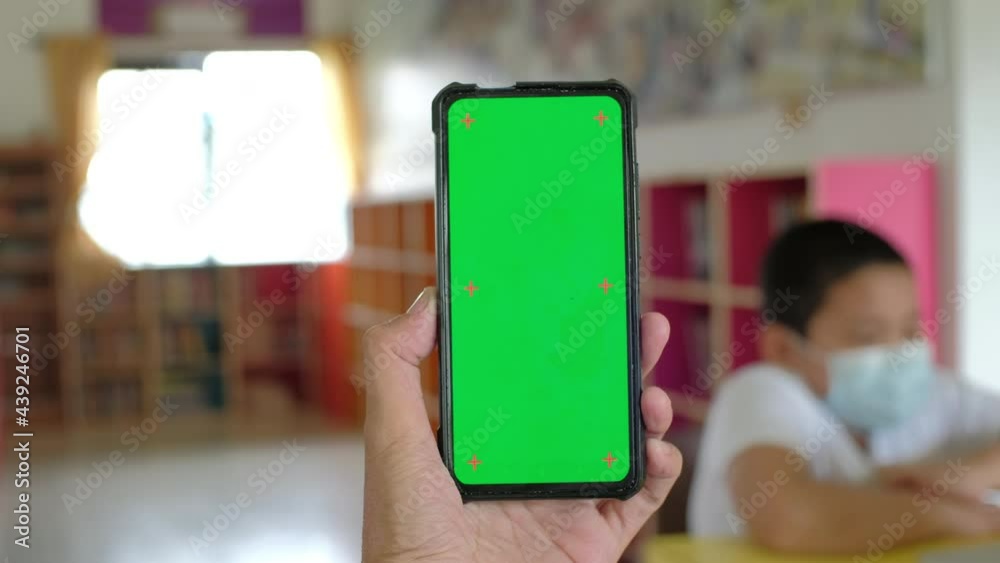 Man hand holding smart phone with chroma key green screen display ...