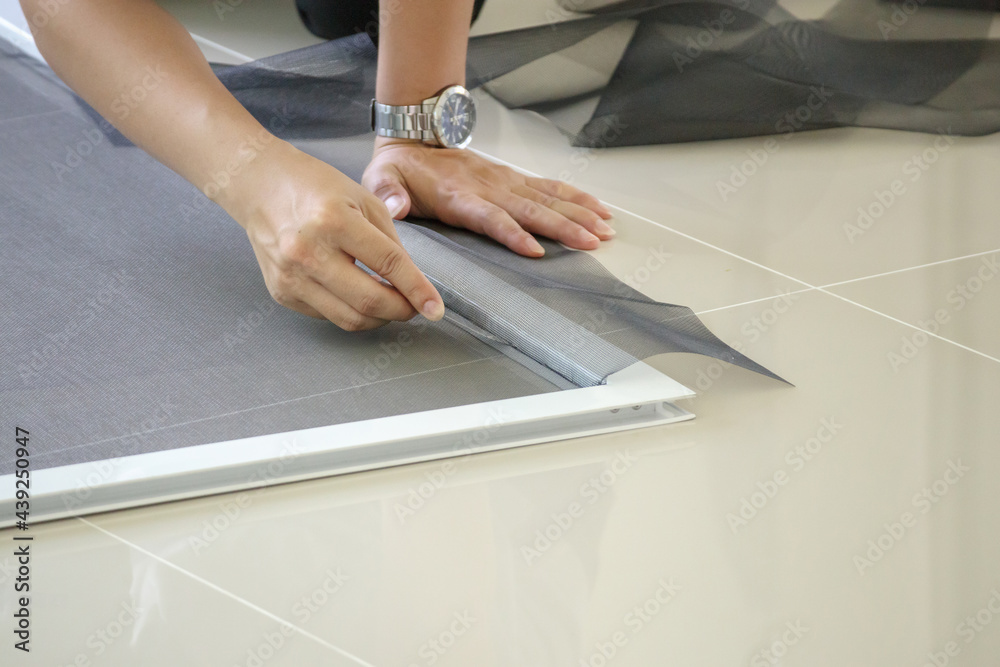 man install mosquito net wire screen on house window protection against ...