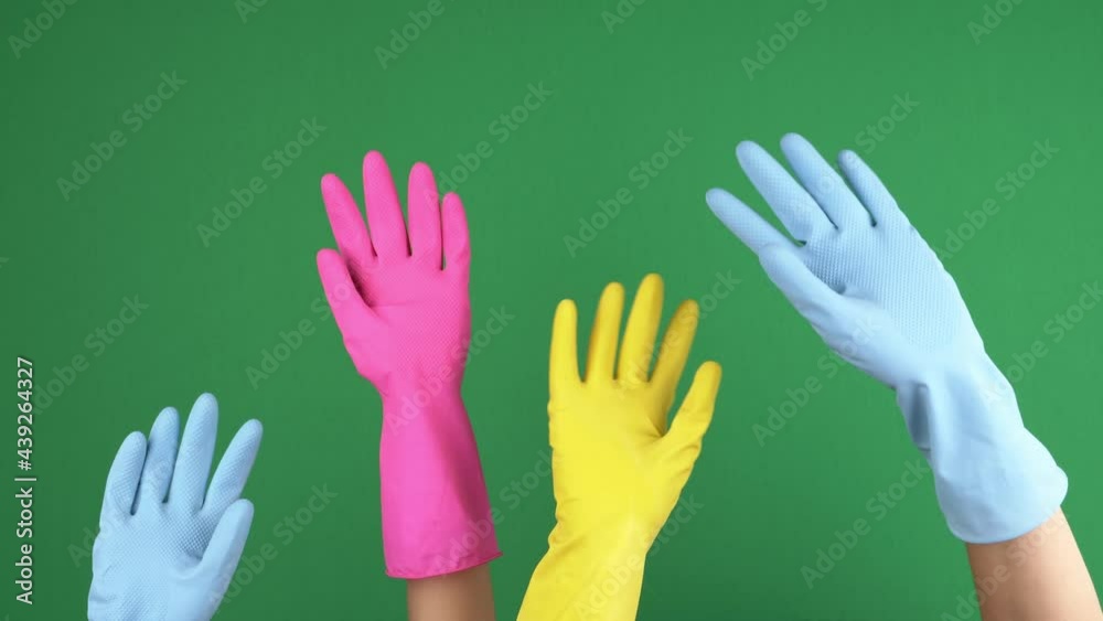 Hands with protective rubber gloves rising up and starts waving, making ...