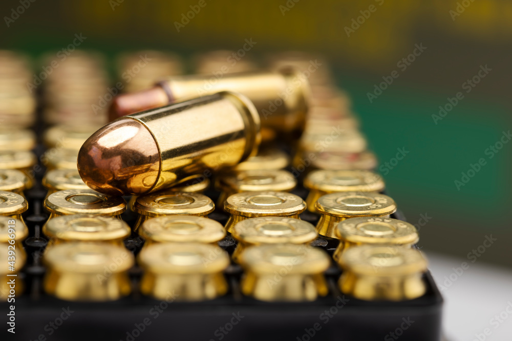 .45 ACP bullet pistol gun with green army ammo box background Stock ...