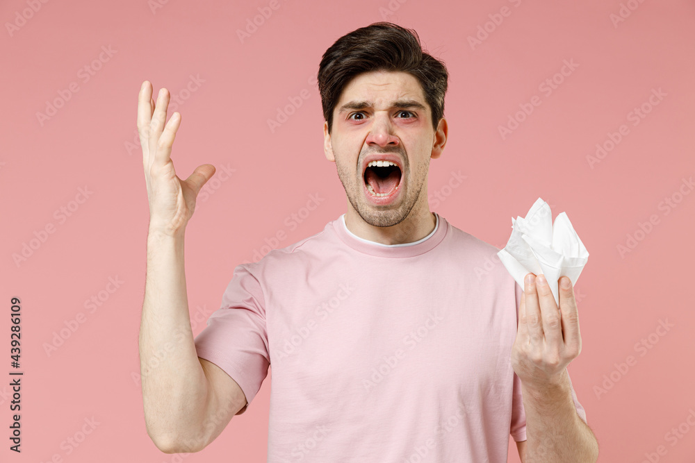 Shocked unhappy sick allergic man has watery red eyes runny nose suffer ...