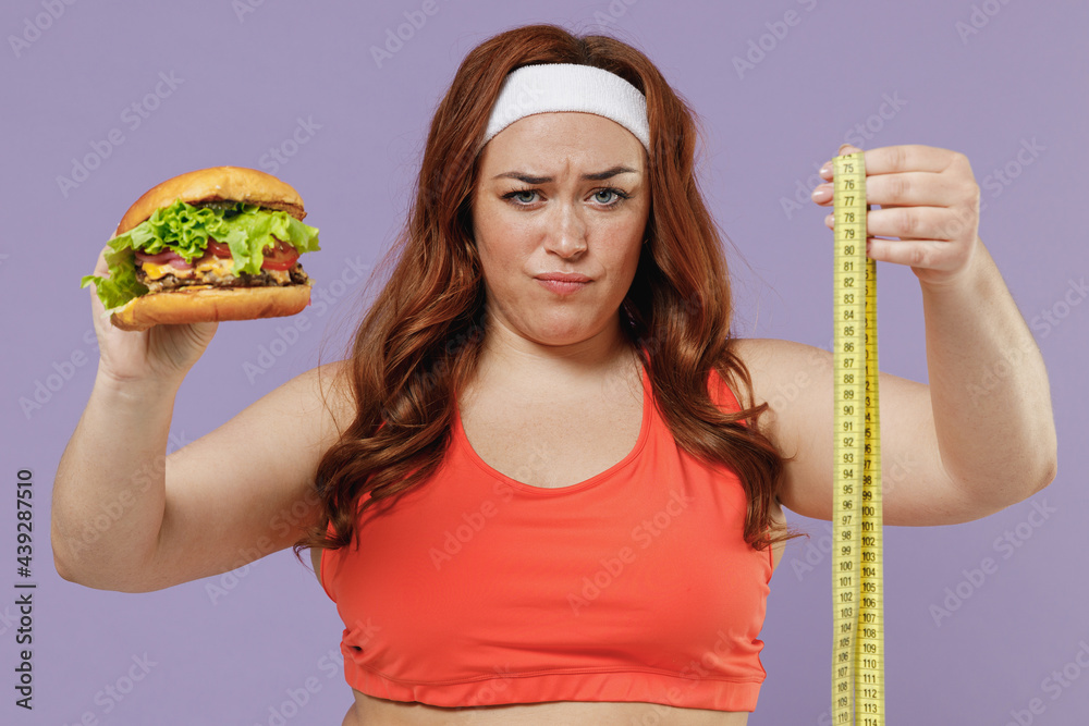 Young disappointed chubby overweight plus size big fat fit woman in red ...