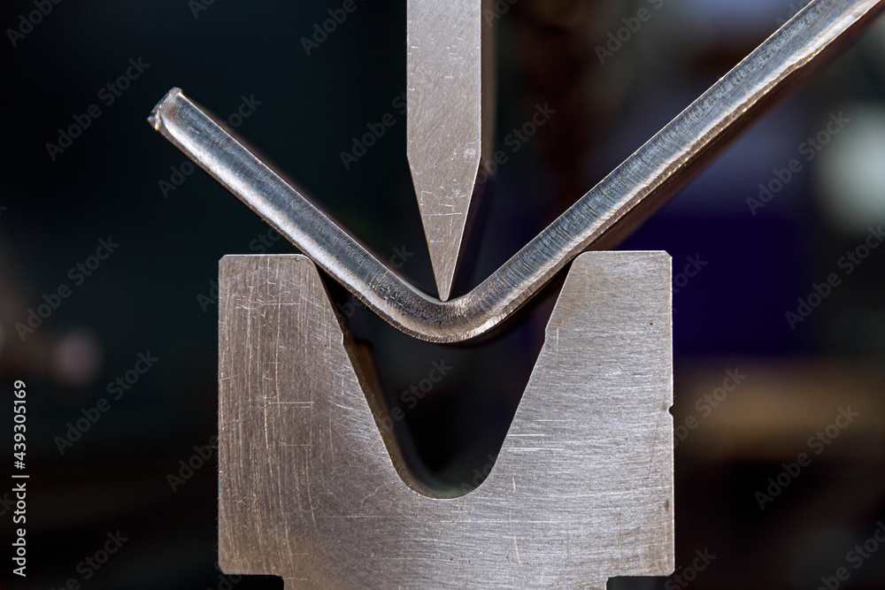 The process of metal bending on a CNC bending machine. Bending of metal ...