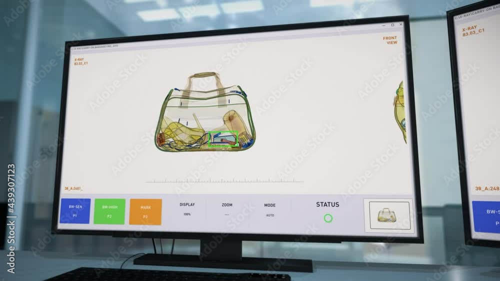 Computer Monitors. An X-Ray Scanner is Analyzing the baggage. Baggage ...