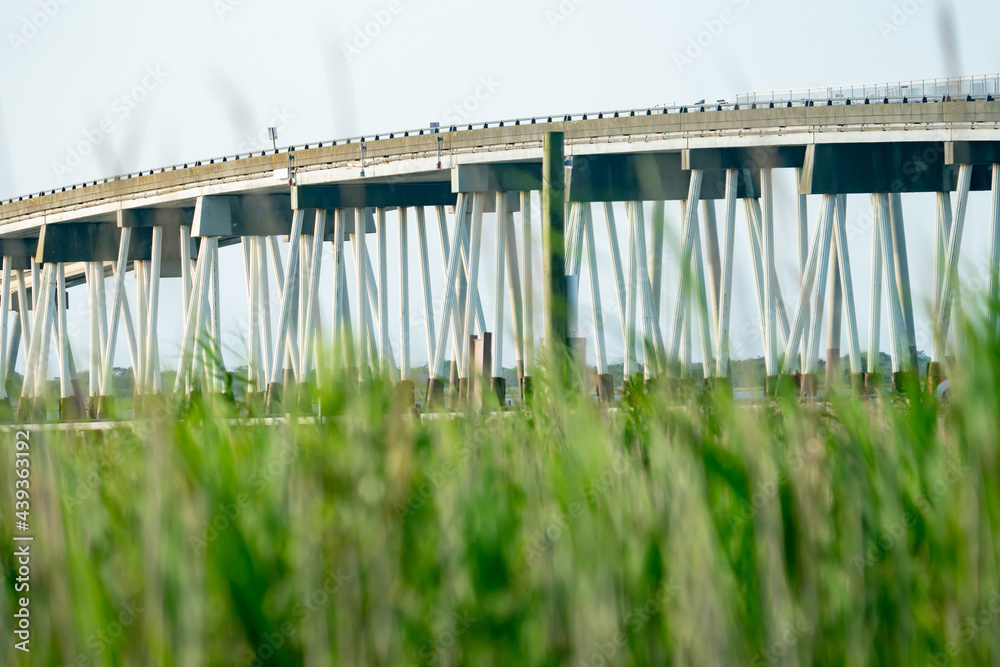 An aging two lane high arch automobile bridge spanning over a coastal ...
