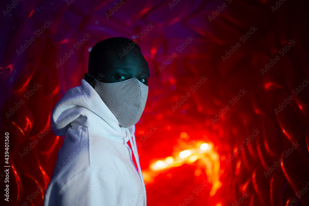 Stylish black man in dark room with red illumination Stock Photo ...