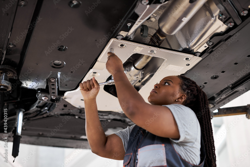 Black Female Auto Mechanic Working Underneath Car In Garage. Portrait ...