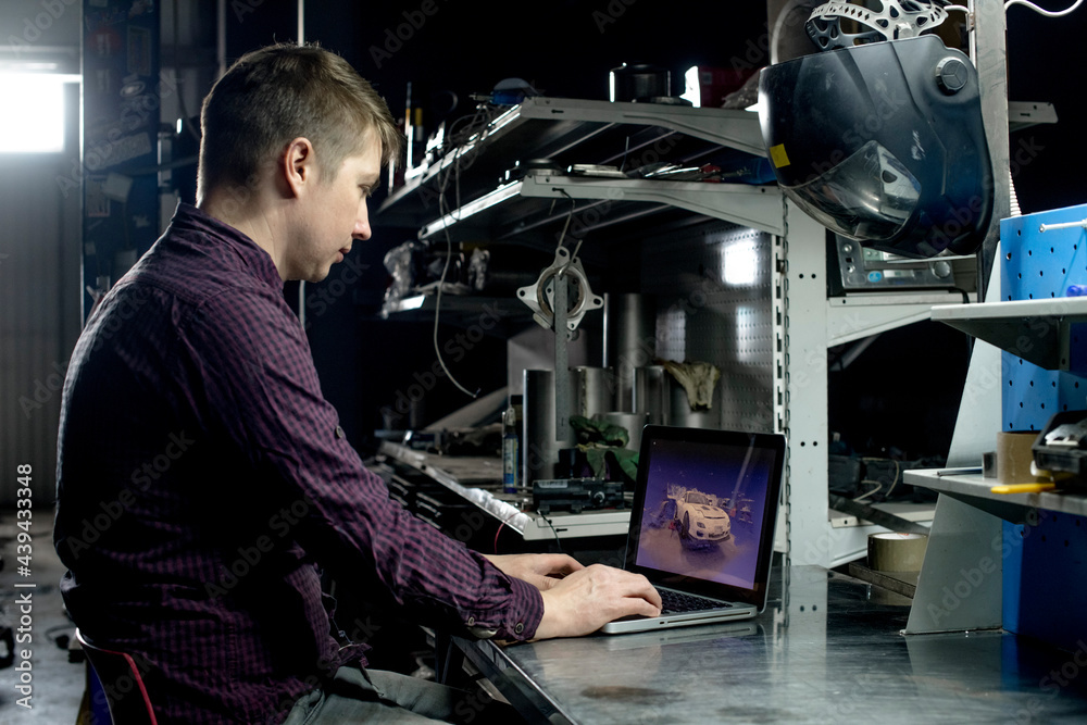 Man working with 3D model of car made by pointcloud inside of service ...