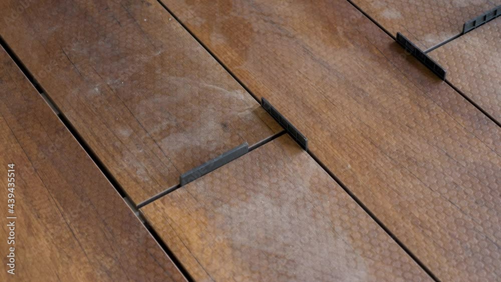 Carpenter sets spacing of deck boards on floor wood panel. Flooring ...