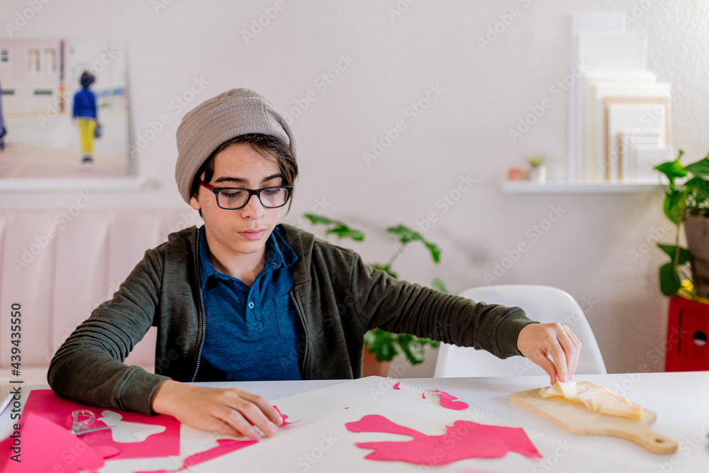 Pre-teen boy making art and craft at home Stock Photo | Adobe Stock